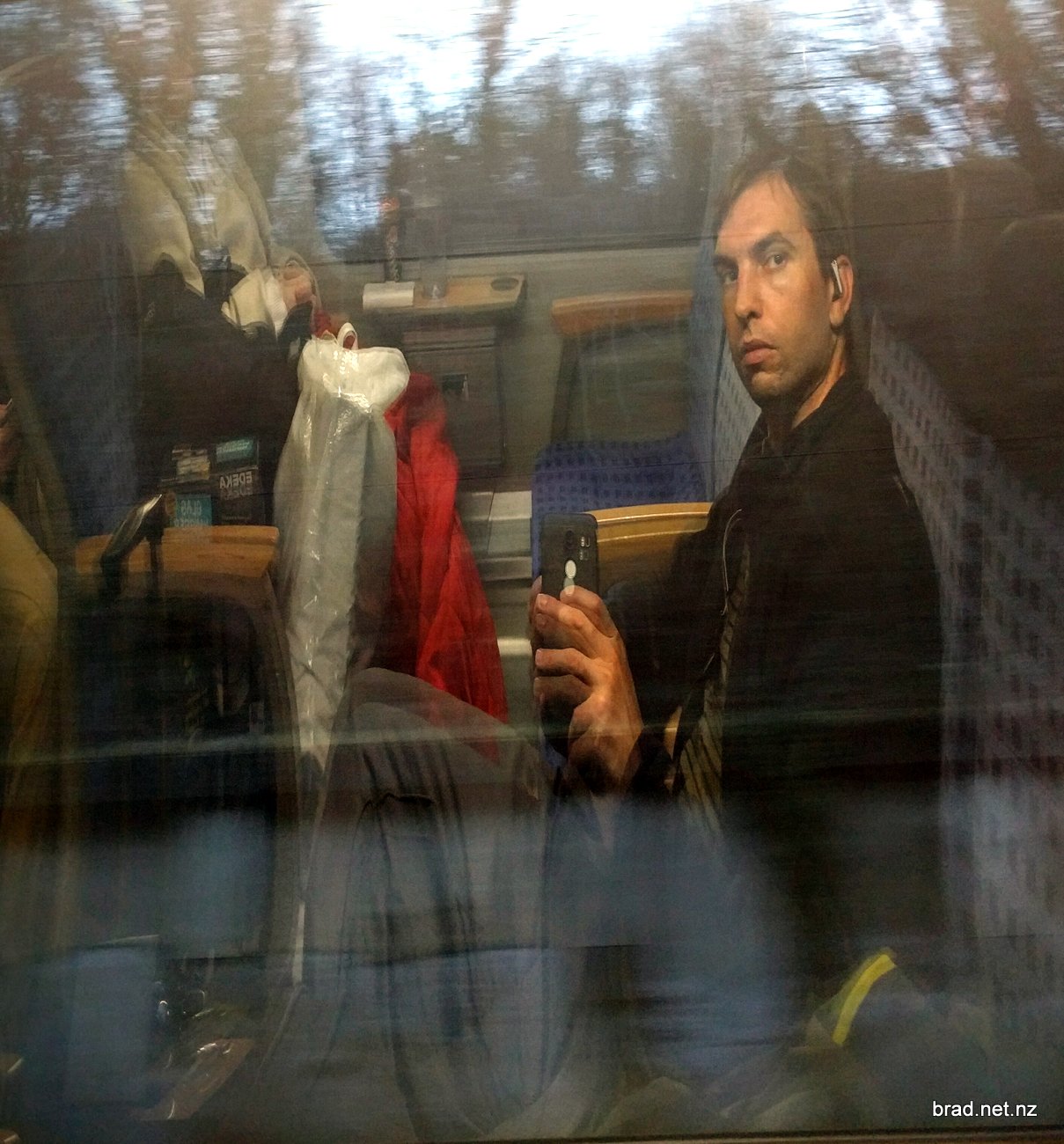 Playing with reflections in the train window – Brad